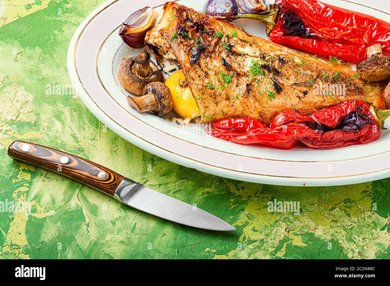 Red sea bass baked with mushrooms and red pepper.Fish in roasted ...