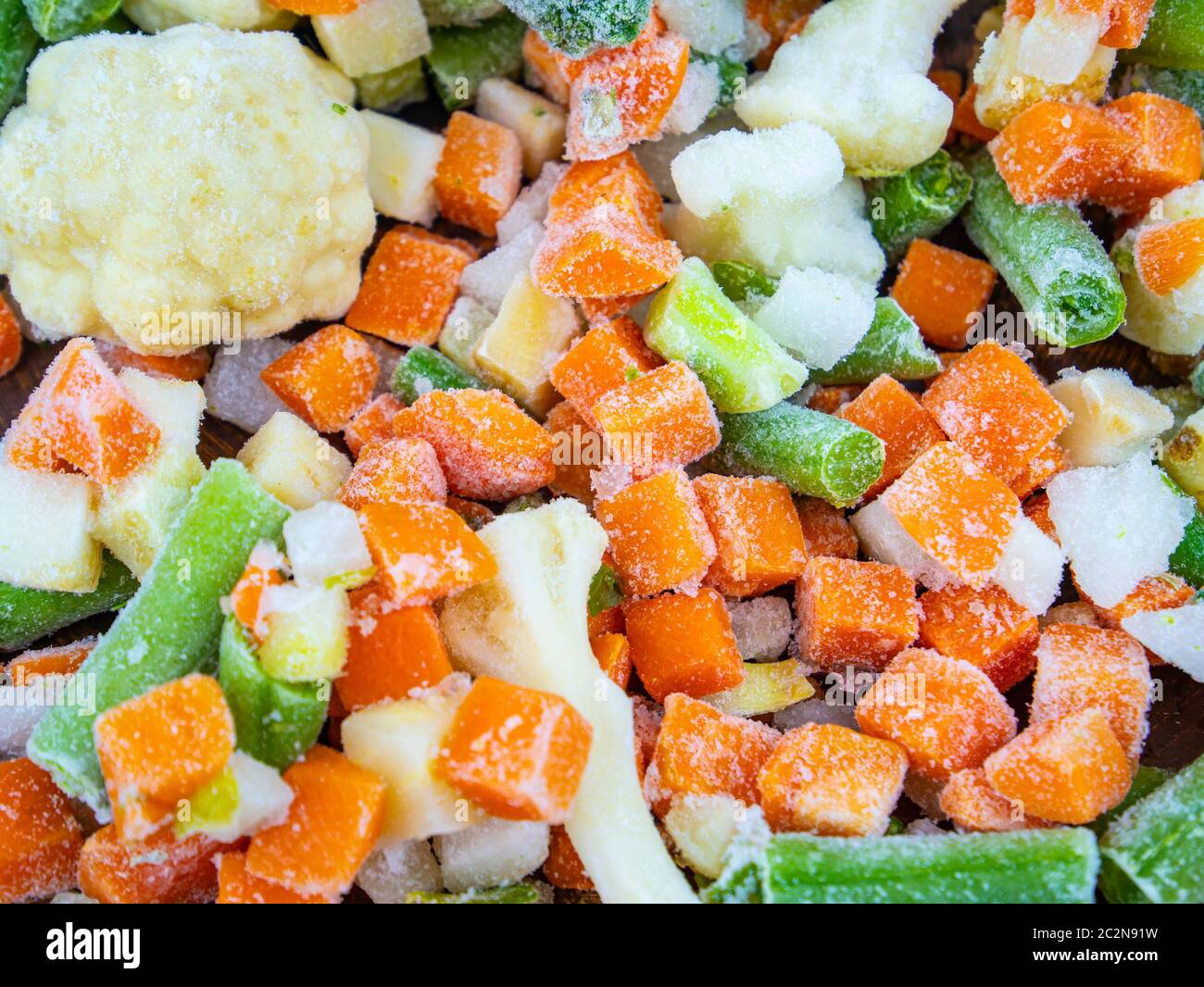 Sliced frozen vegetables on a white background. Food photo Stock Photo ...
