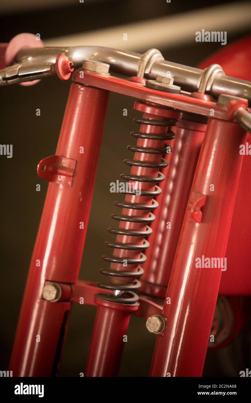 Color vertical close up of the front suspension of a red vintage ...