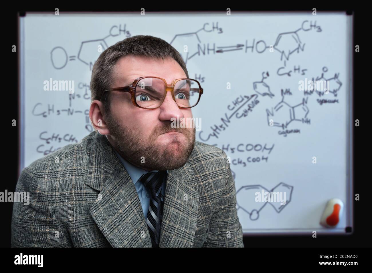Bizarre professor in glasses thinking over chemical formulas Stock ...