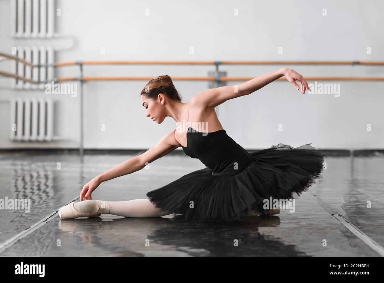 Female ballet dancer posing on rehearsal in class. Ballerina dance ...