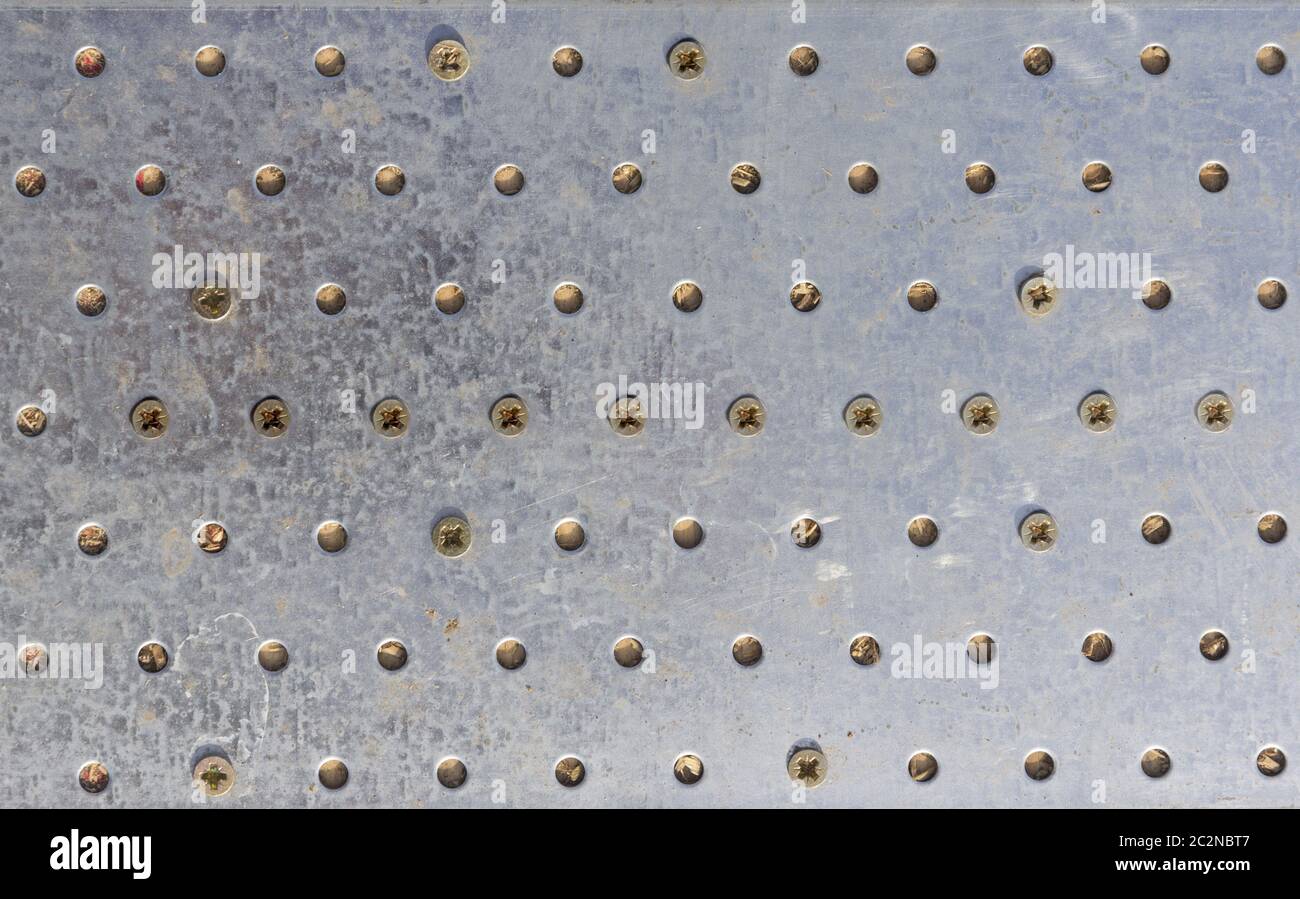 Texture of the metal plate with bolts and holes Stock Photo - Alamy