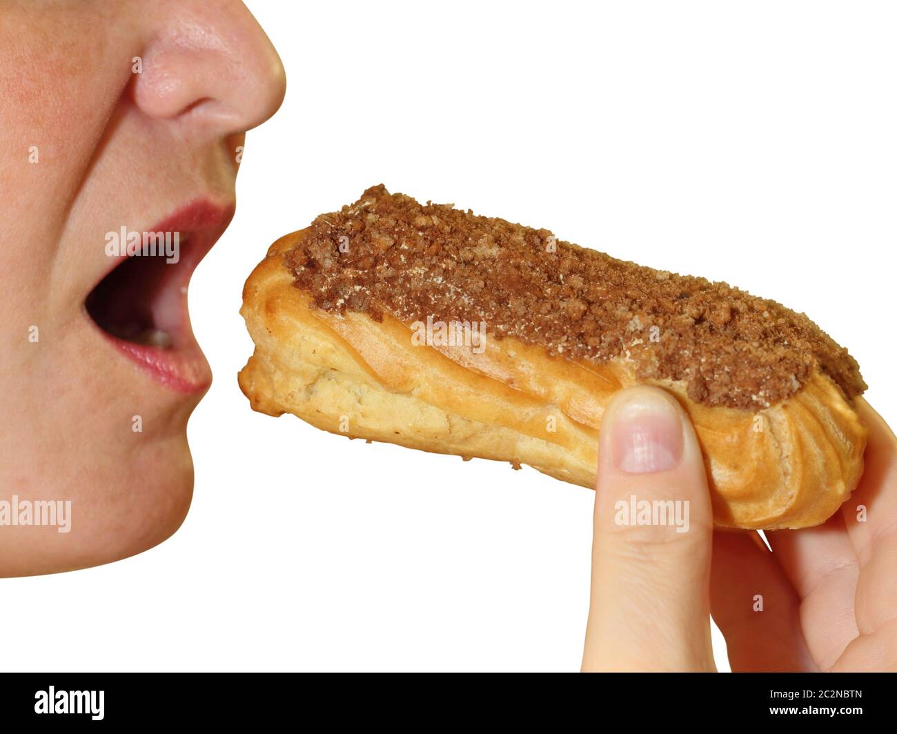 Close up of a young woman eating a cake eclair over white background ...