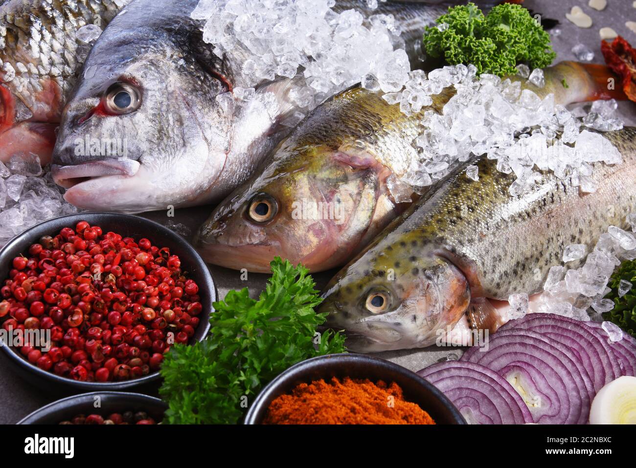Different sorts of fish on kitchen table Stock Photo - Alamy