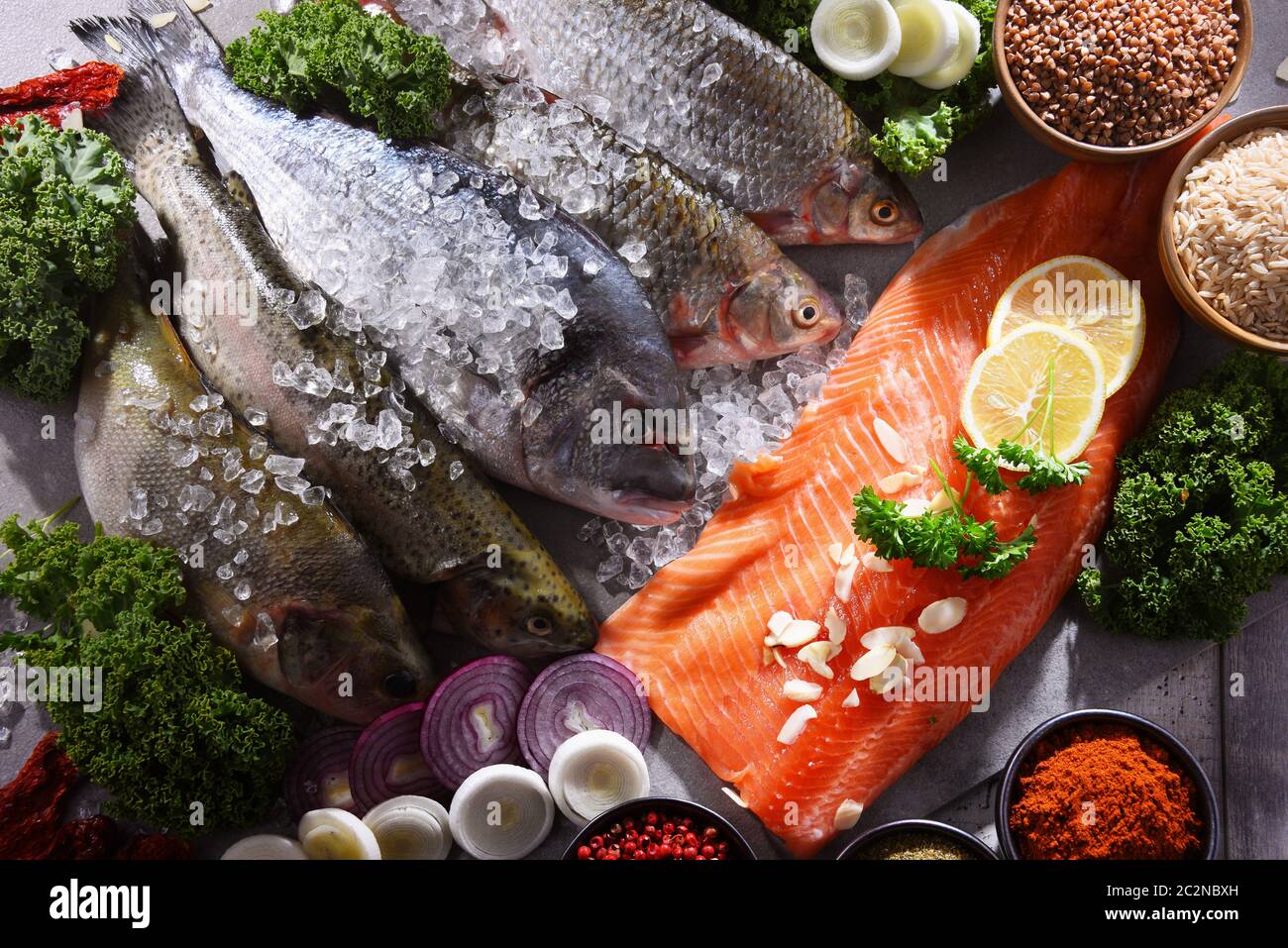 Different sorts of fish on kitchen table Stock Photo - Alamy