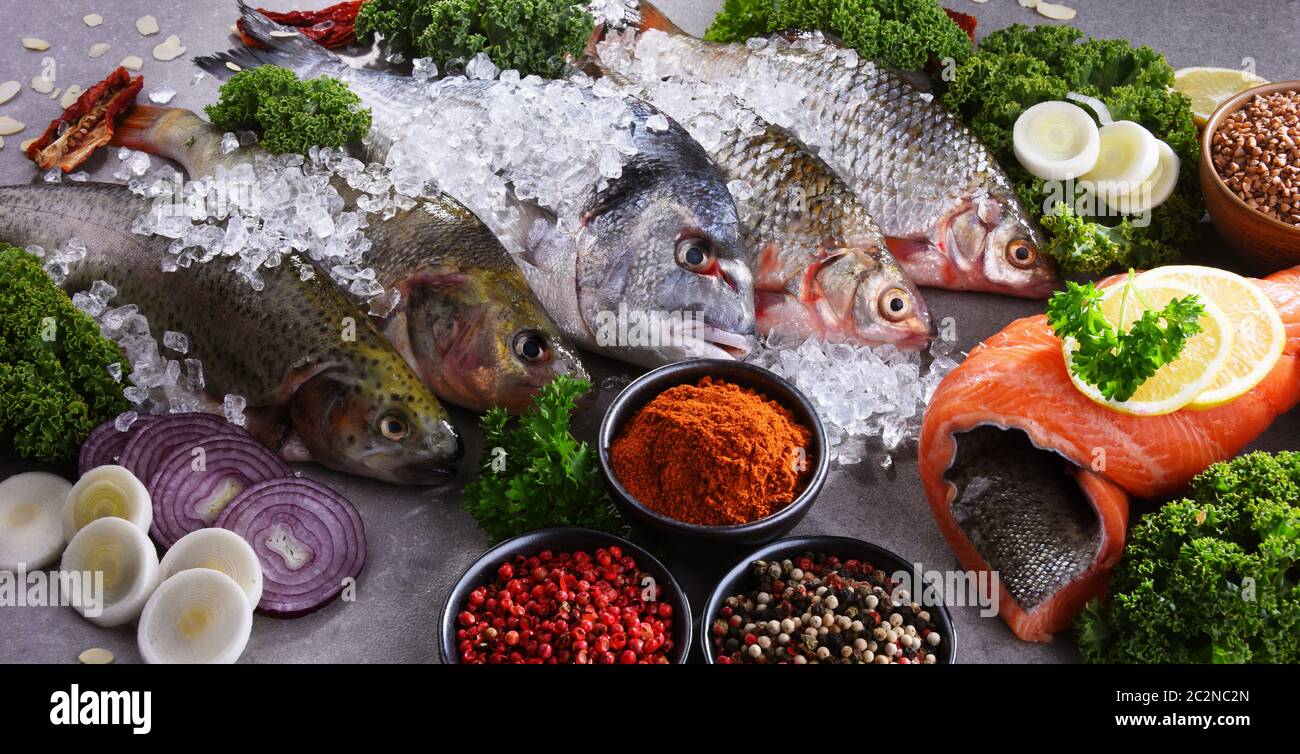 Different sorts of fish on kitchen table Stock Photo - Alamy