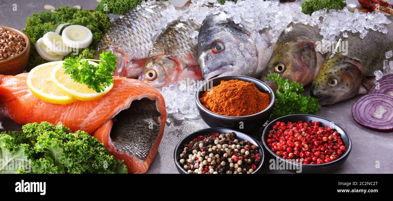 Different sorts of fish on kitchen table Stock Photo - Alamy