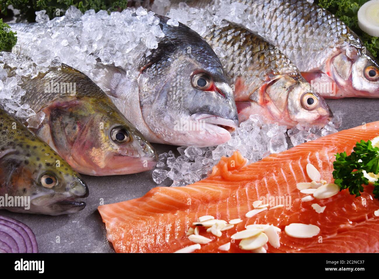 Different sorts of fish on kitchen table Stock Photo - Alamy