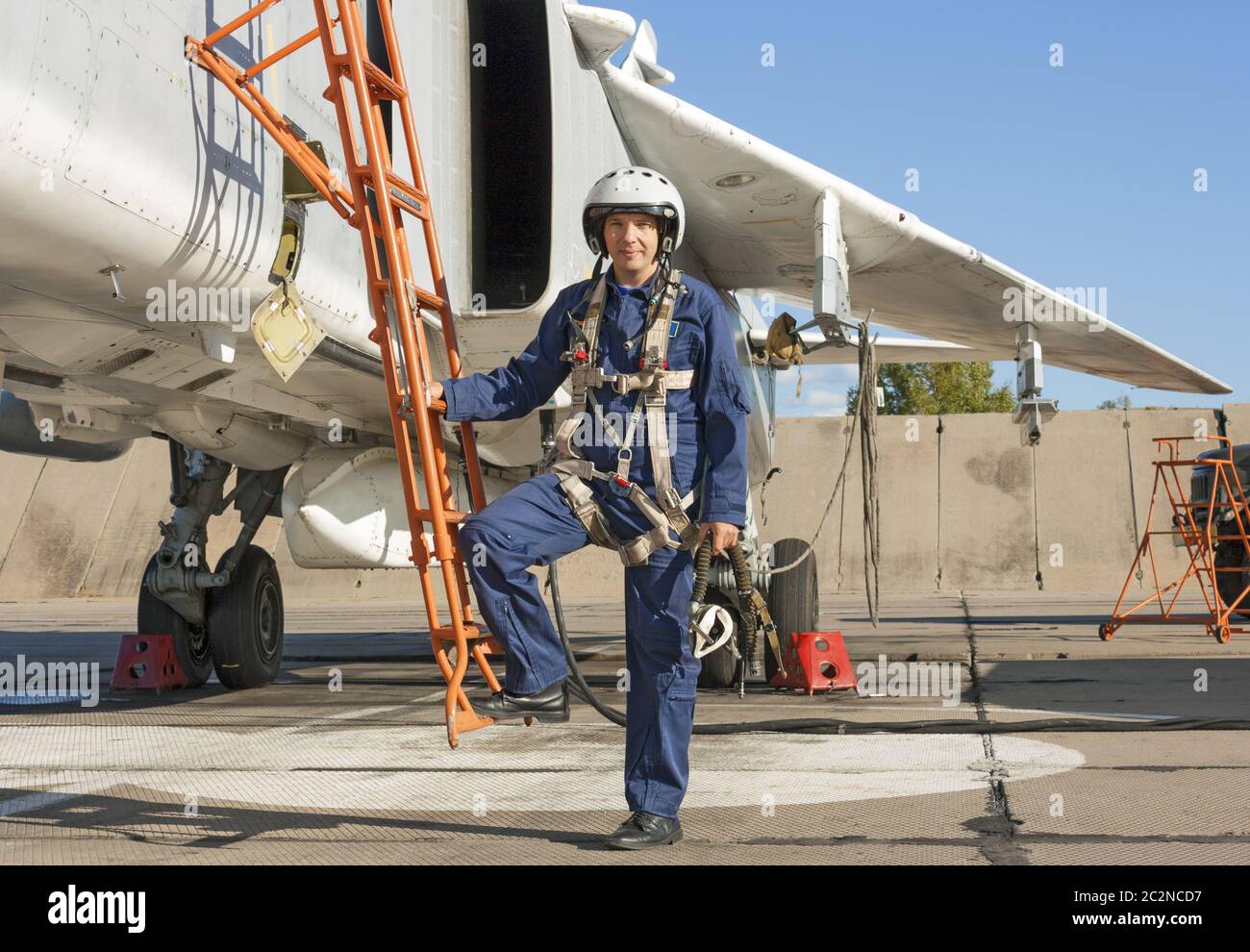 Military pilot in helmet stands near jet plane Stock Photo - Alamy