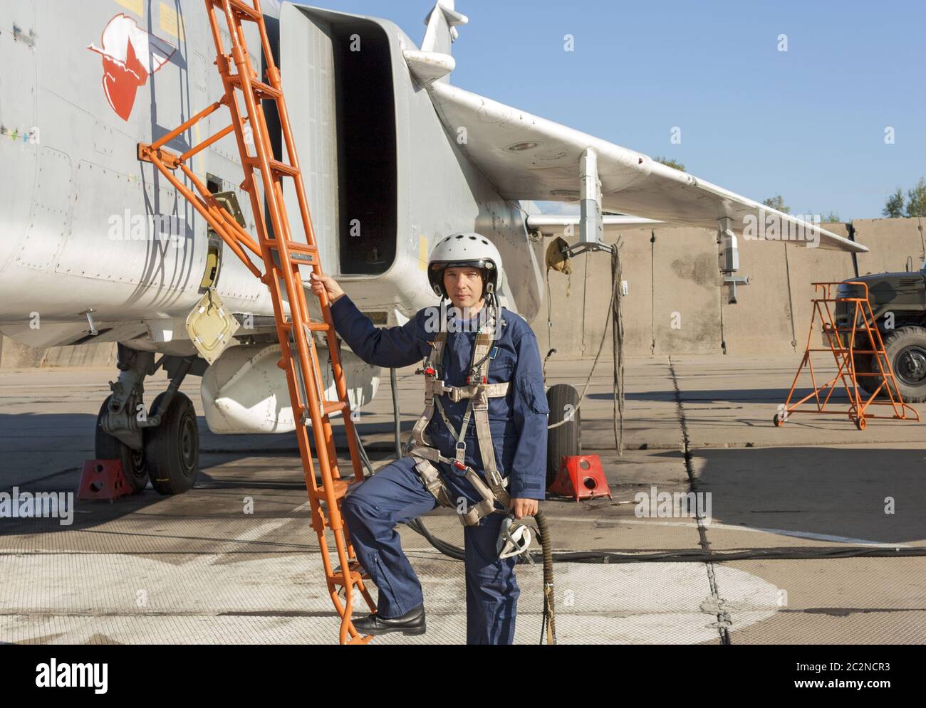 Military pilot in helmet stands near jet plane Stock Photo - Alamy