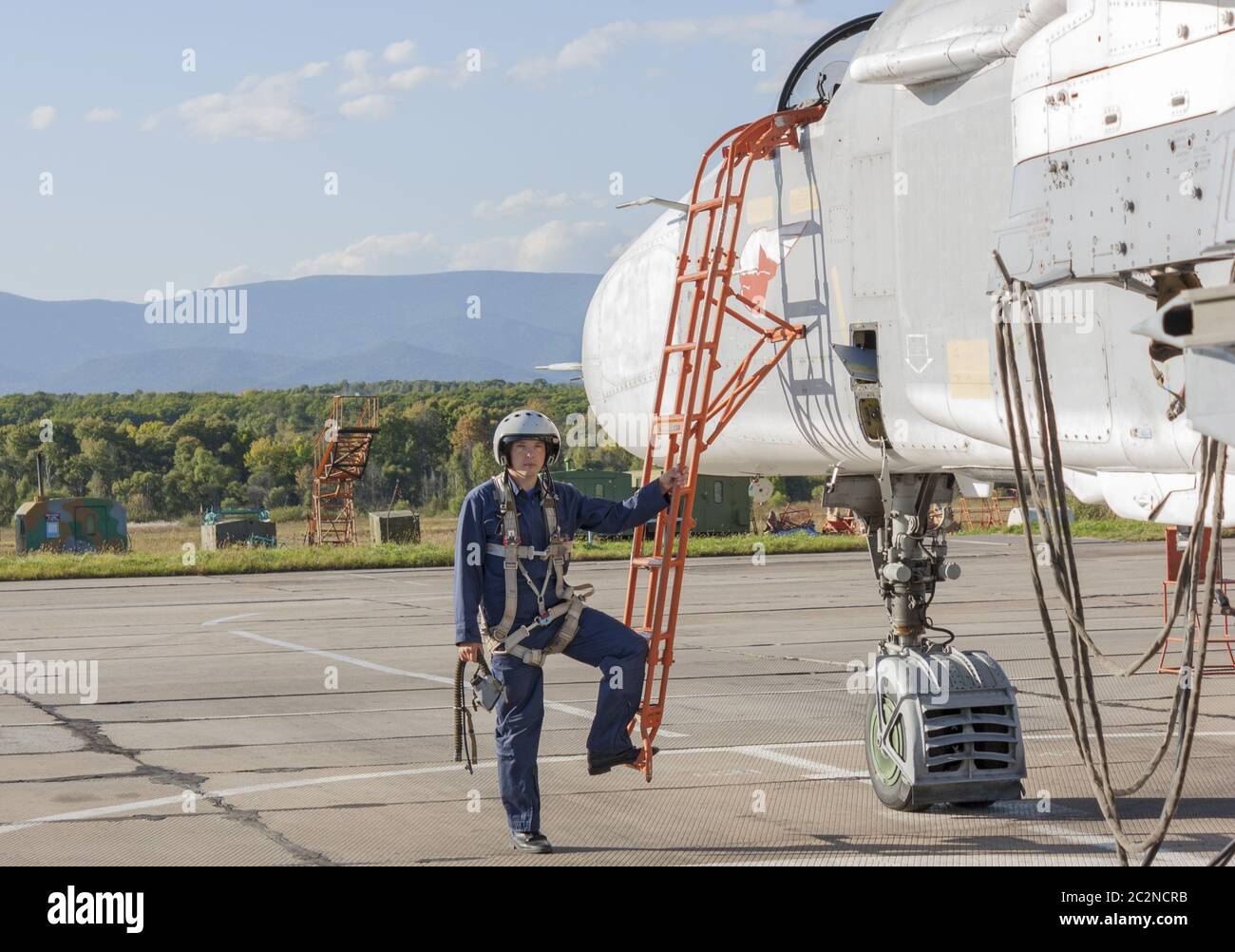 Military pilot in helmet stands near jet plane Stock Photo - Alamy