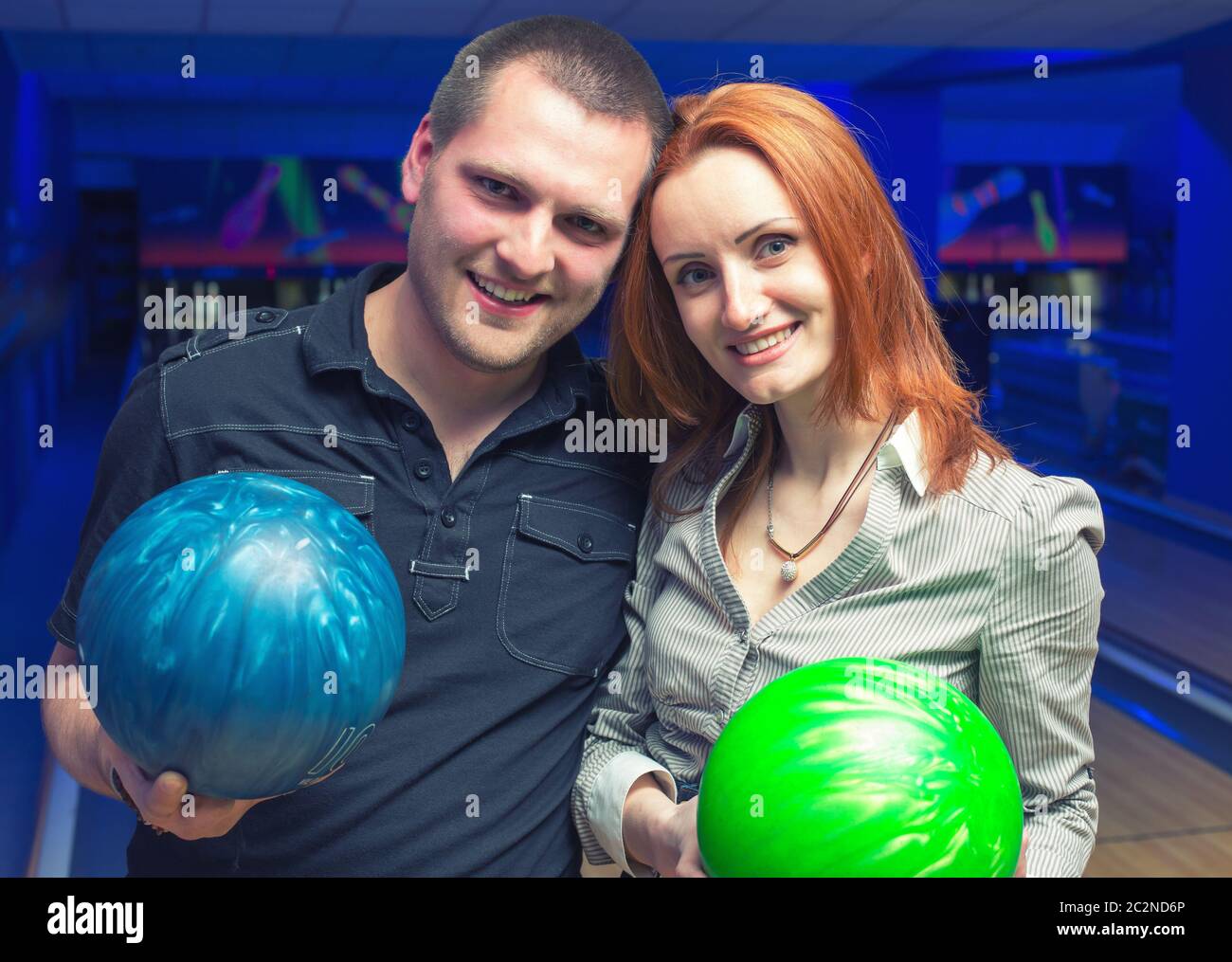 Happy couple in a bowling alley having fun Stock Photo - Alamy