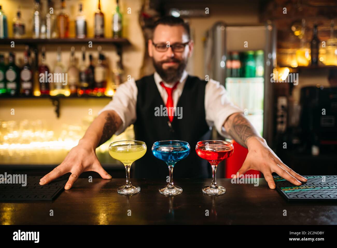 Bartender behind bar counter show alcohol coctails in restaurant Stock ...