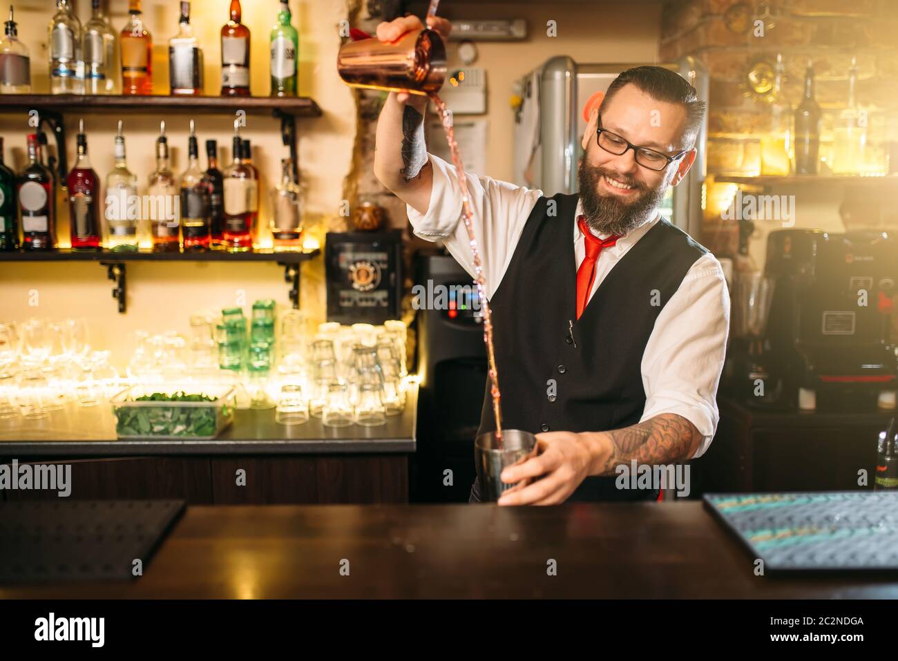 Barkeeper show behind restaurant bar counter. Handsome alcohol beverage ...