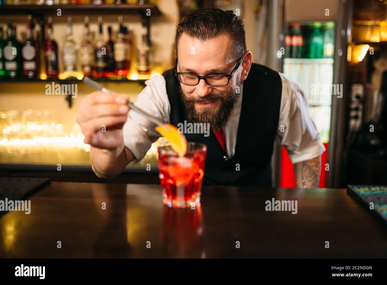 Bartender behind bar counter making alcohol coctail in restaurant Stock ...