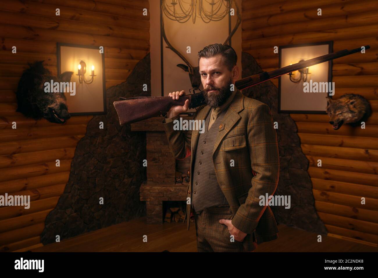 Hunter man with old gun in vintage traditional hunting clothing ...