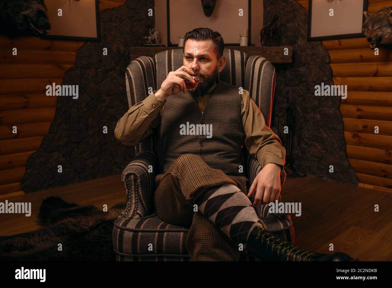 Hunter man in traditional vintage hunting clothing drink luxury alcohol ...