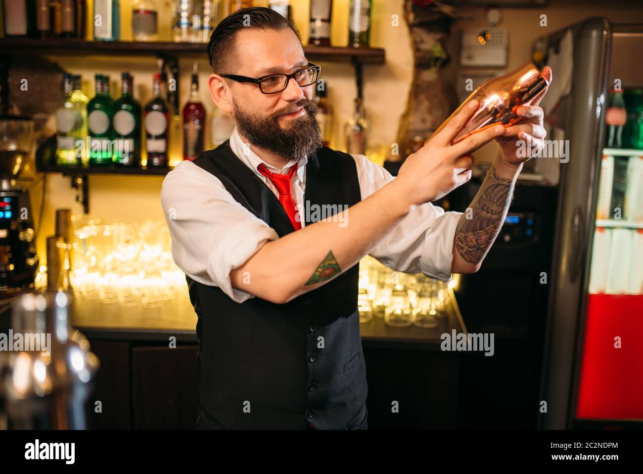 Bartender flair with shaker behind a bar counter. Barman flairing Stock ...