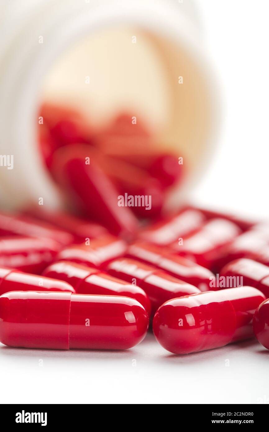 Pills spilling from an open bottle Stock Photo - Alamy