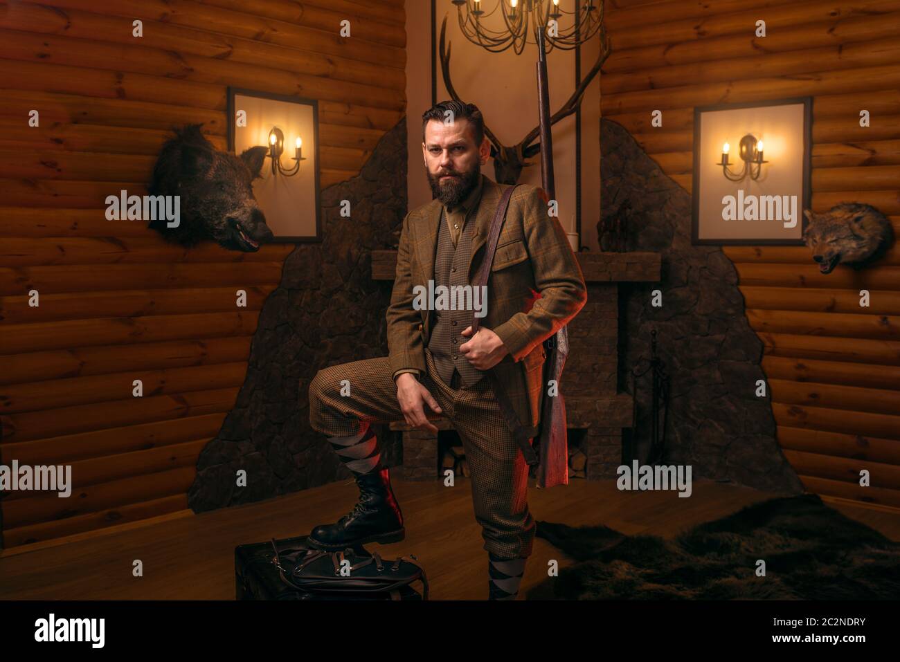 Respectable hunter man with old gun in retrro style traditional hunting ...