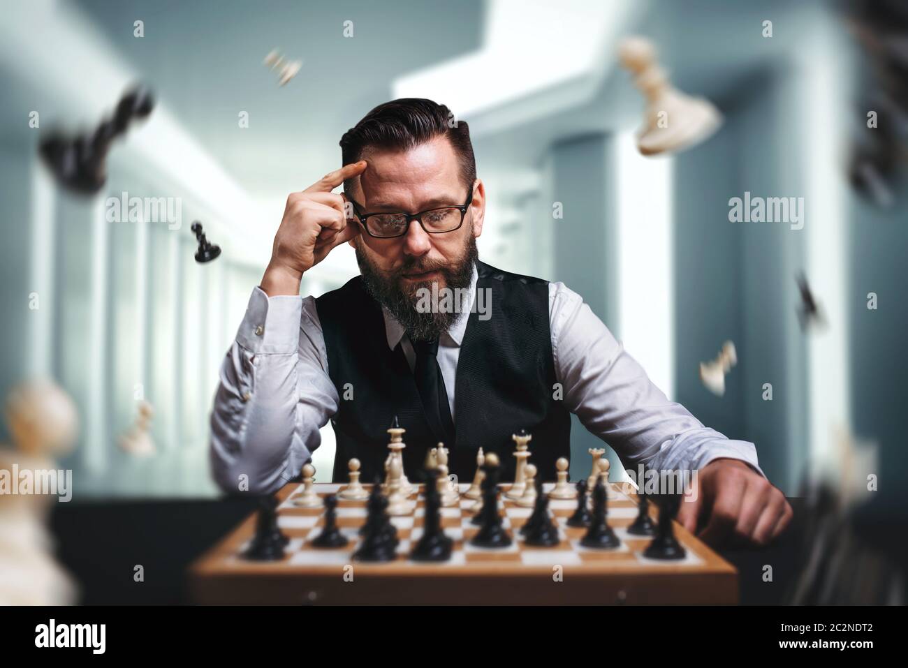 Pensive male chess player in glasses calculate movies and game strategy ...
