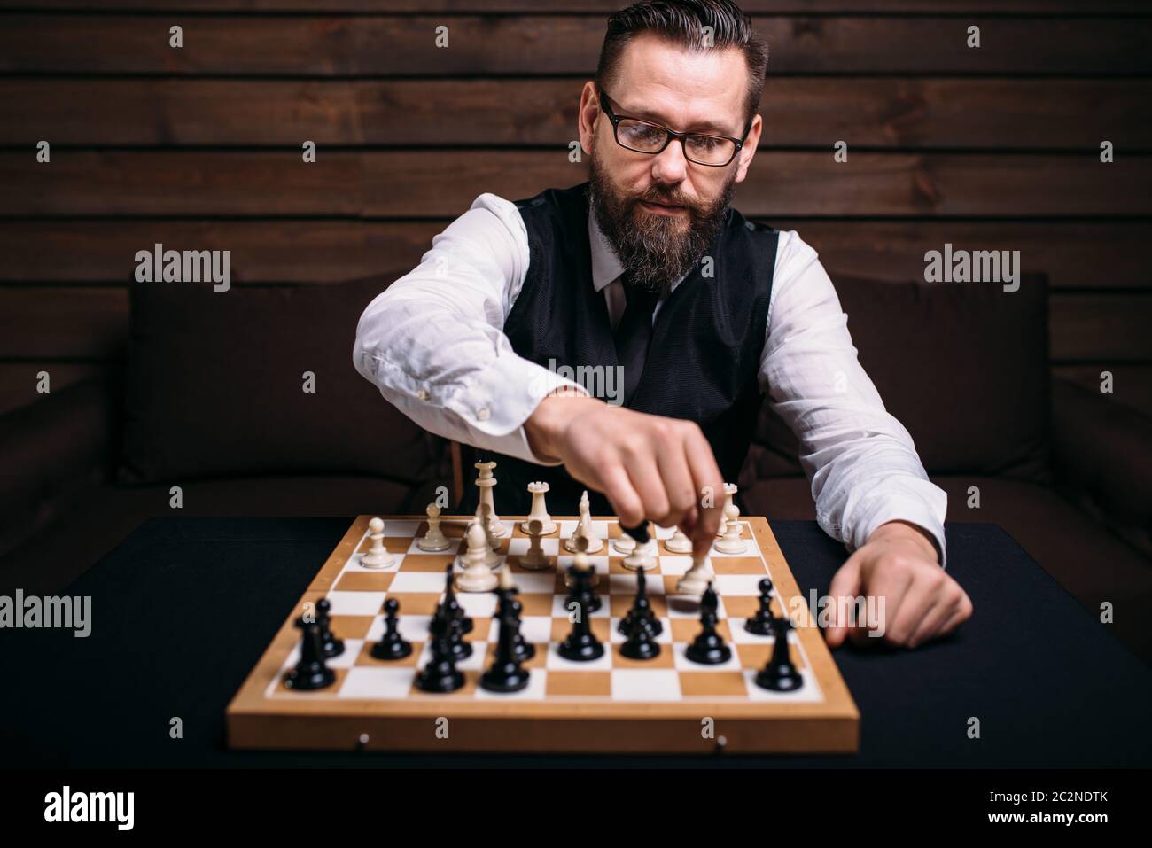 Serious male chess player in glasses makes victory move. Win strategy ...