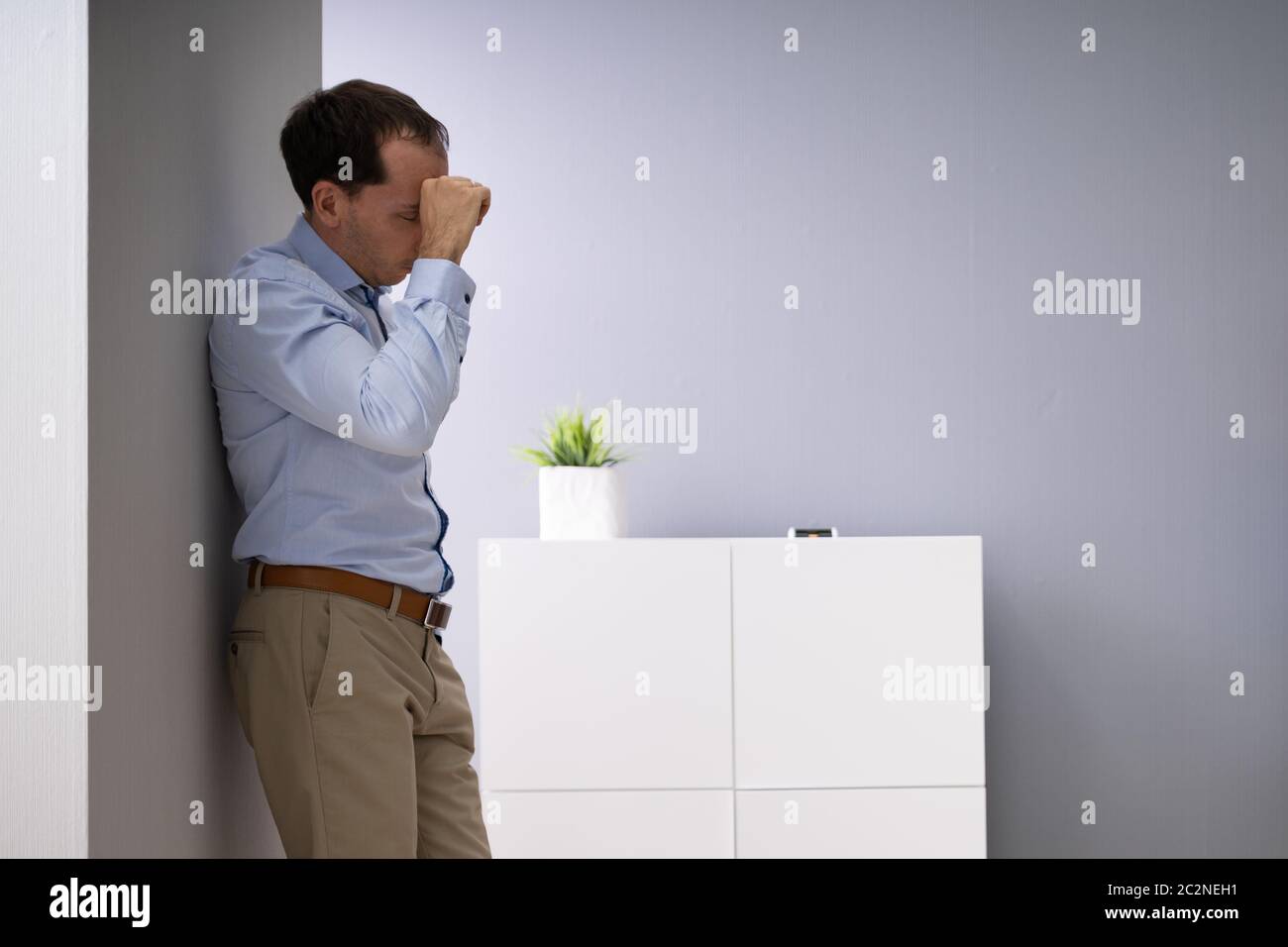 Side View Of A Stressed Businessman Standing In Office Stock Photo - Alamy