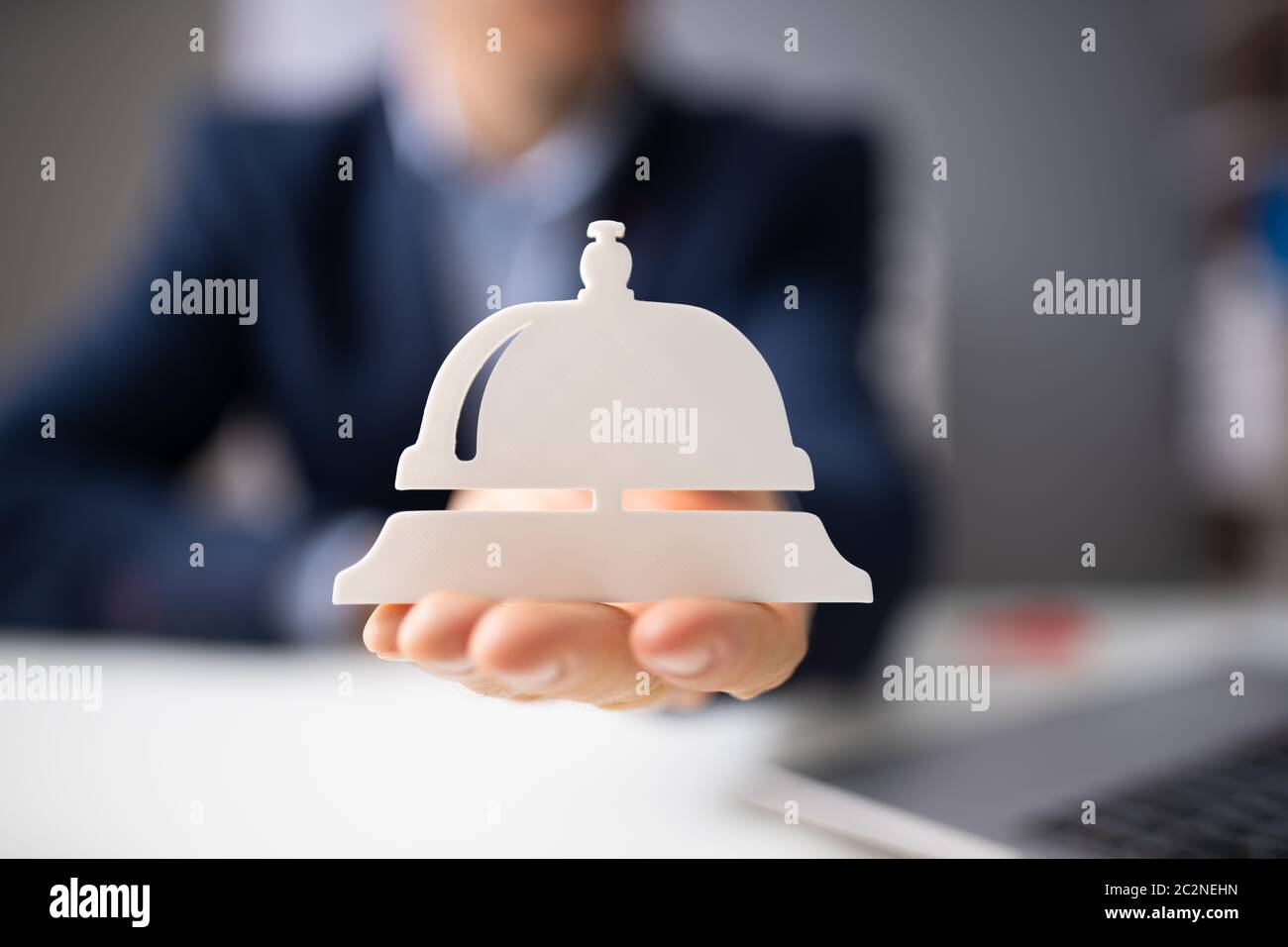 Mid-section Of Male Hand Holding Service Bell Icon Stock Photo - Alamy