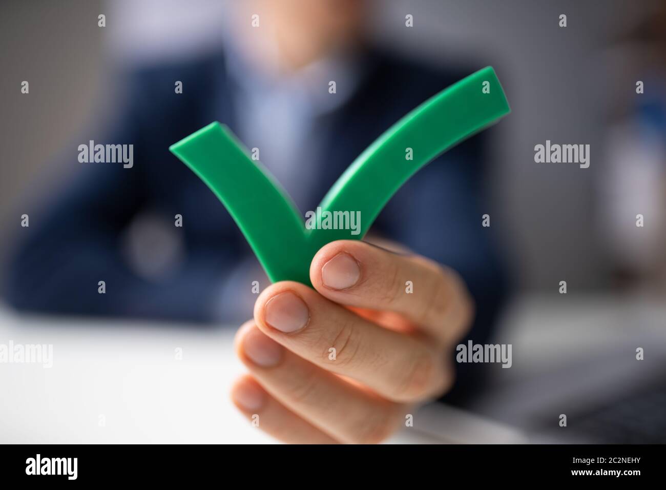 Close-up Of A Businessperson's Hand Holding Green Check Mark Icon Stock ...