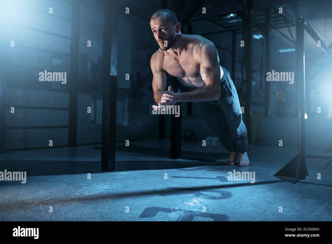 Muscle athlete makes pushups exercises in gym. Strong gymnast on ...