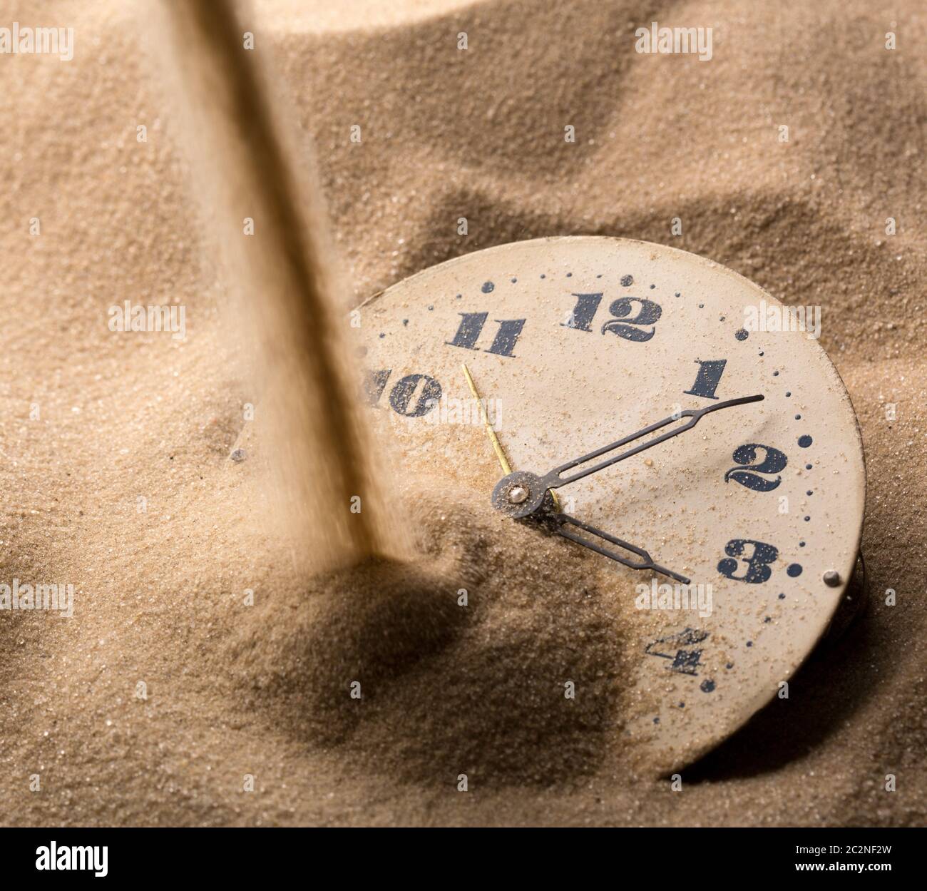 Sand pouring on old clock face Stock Photo - Alamy