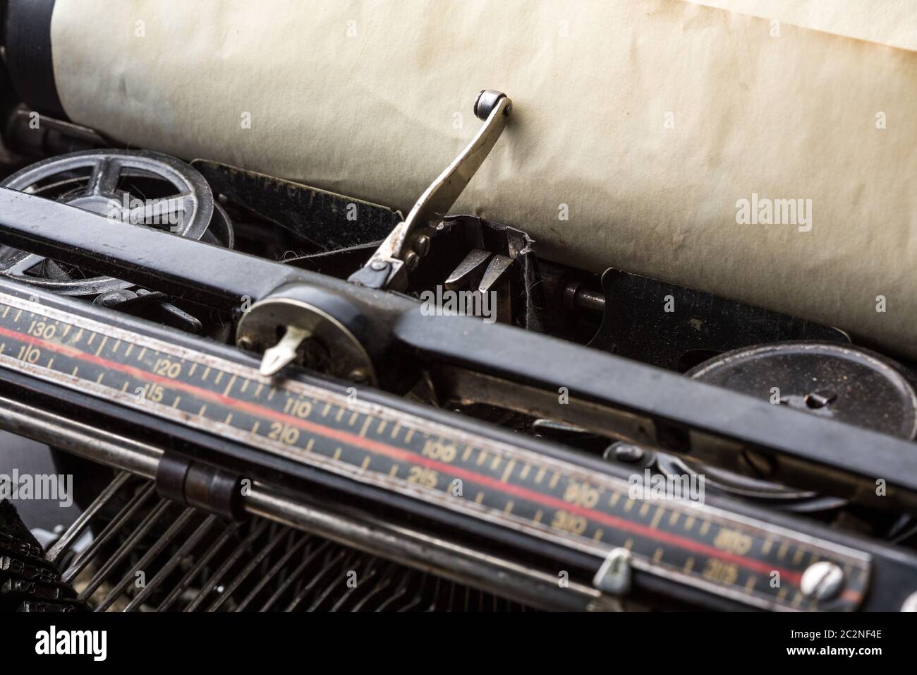 Vintage typewriter ribbon mechanism with inserted old paper closeup ...