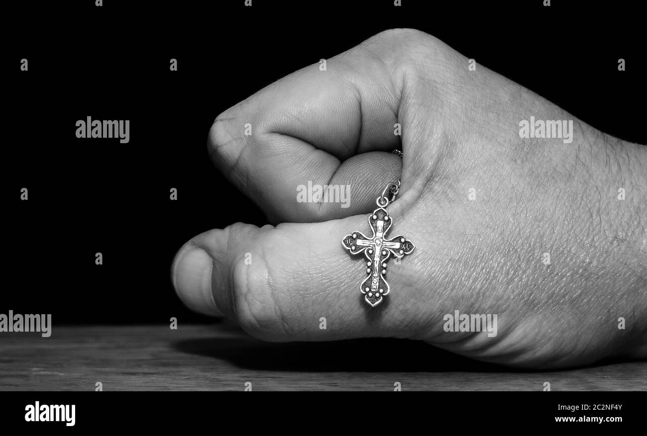 Hand with a cross Stock Photo - Alamy