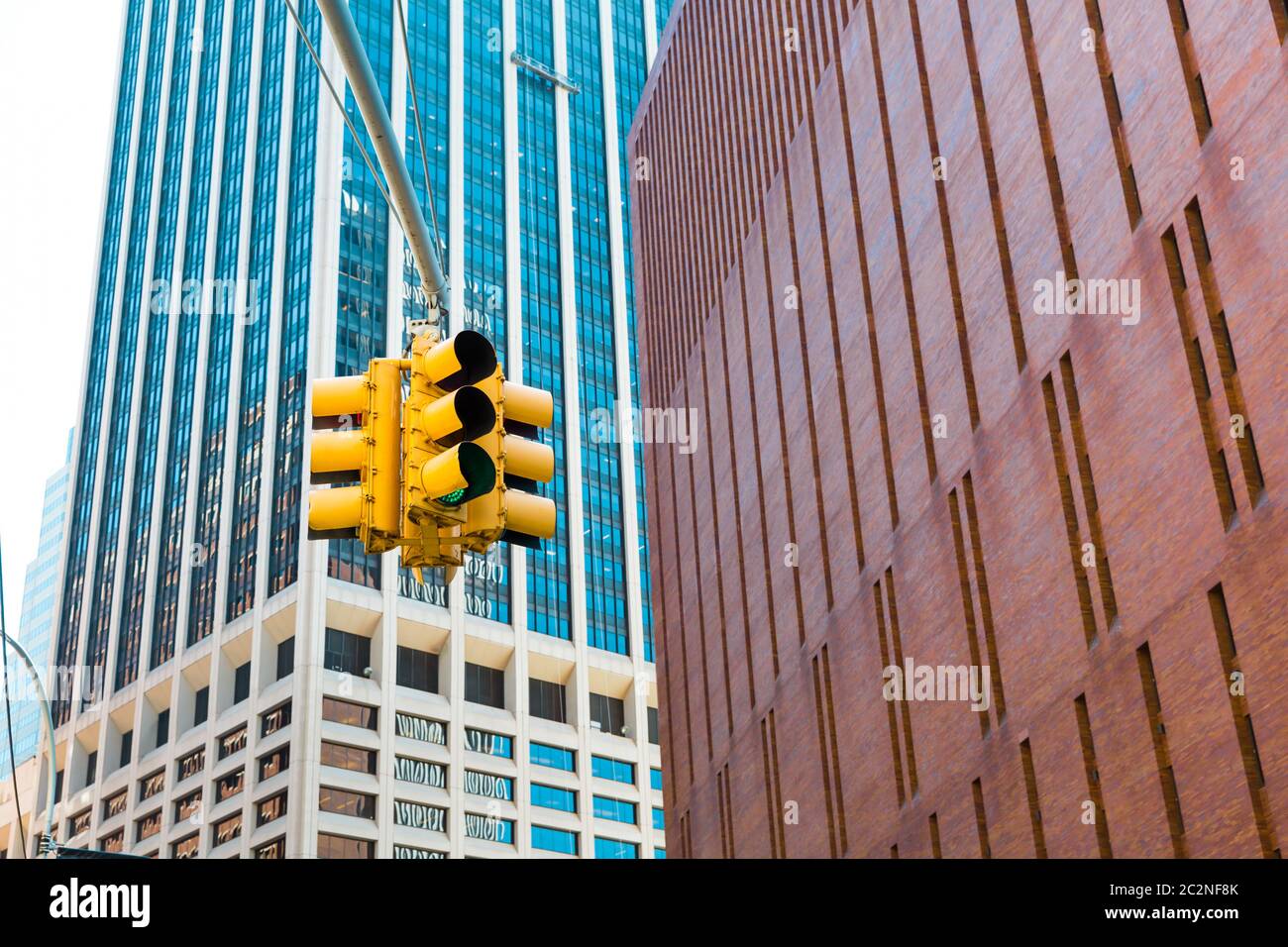 Green traffic light on city street. Urban buildings on the background ...