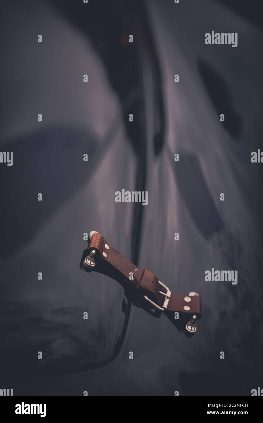 Old classic vintage racing car hood and leather strap Stock Photo - Alamy