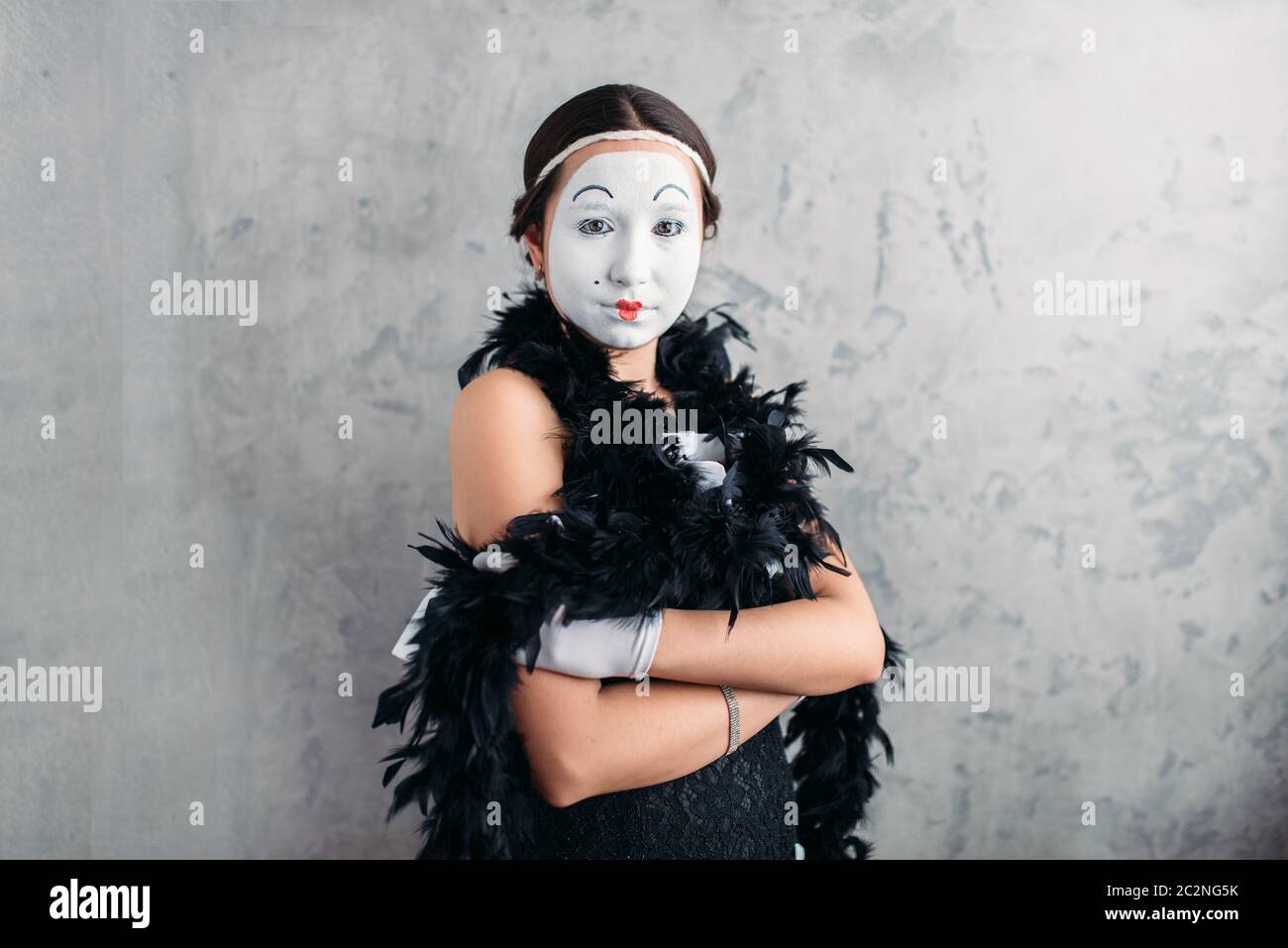 Pantomime actress with white makeup mask posing in studio. Comedy ...