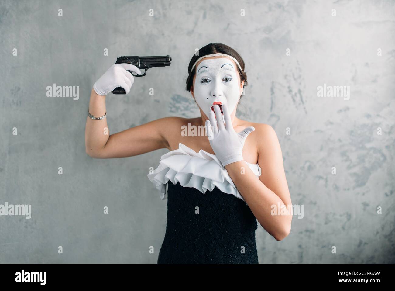 Mime female artist performing with gun. Comedian performer. Pantomime ...