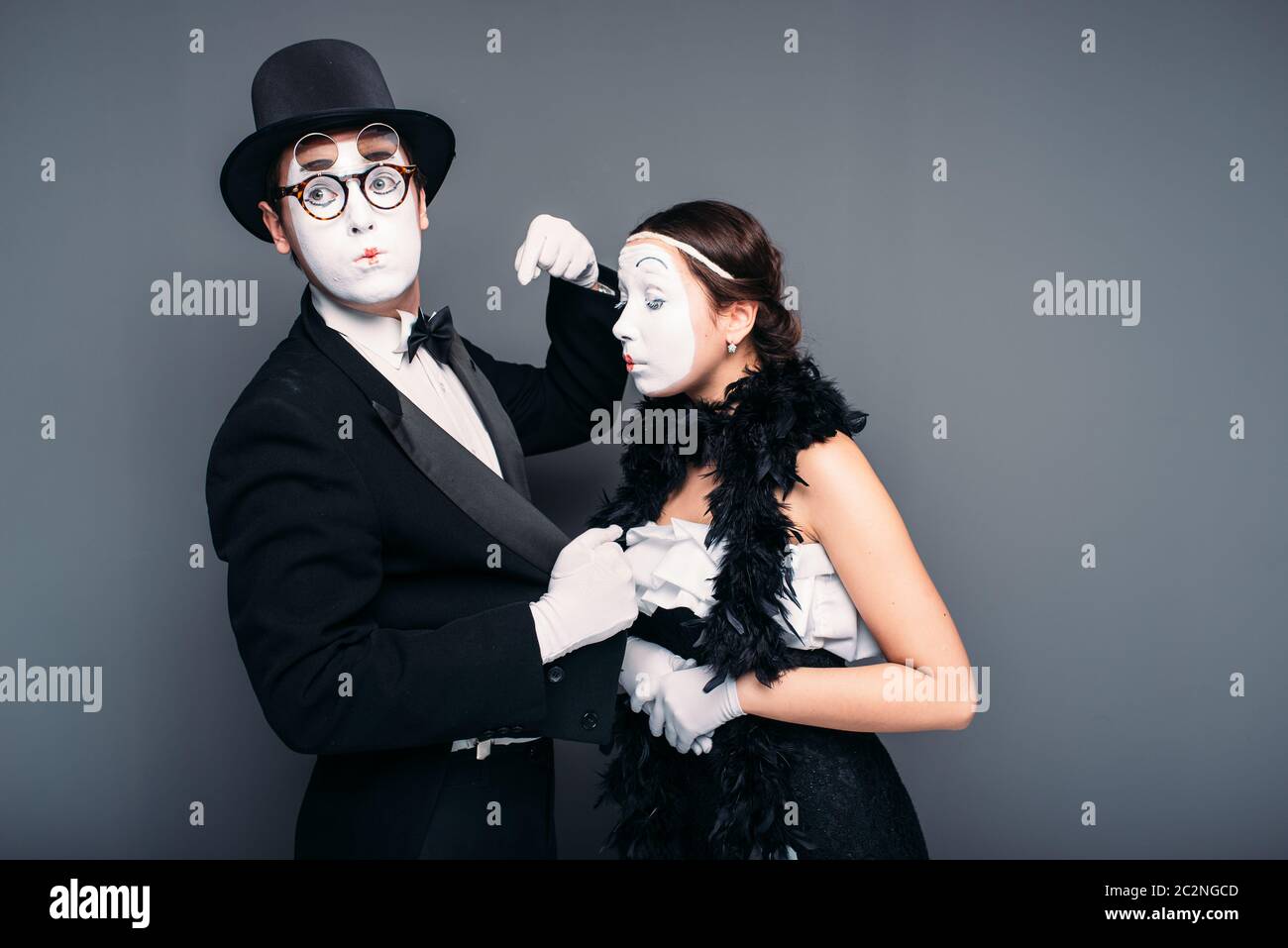 Mime artists with white makeup masks on faces. Pantomime theater actor ...