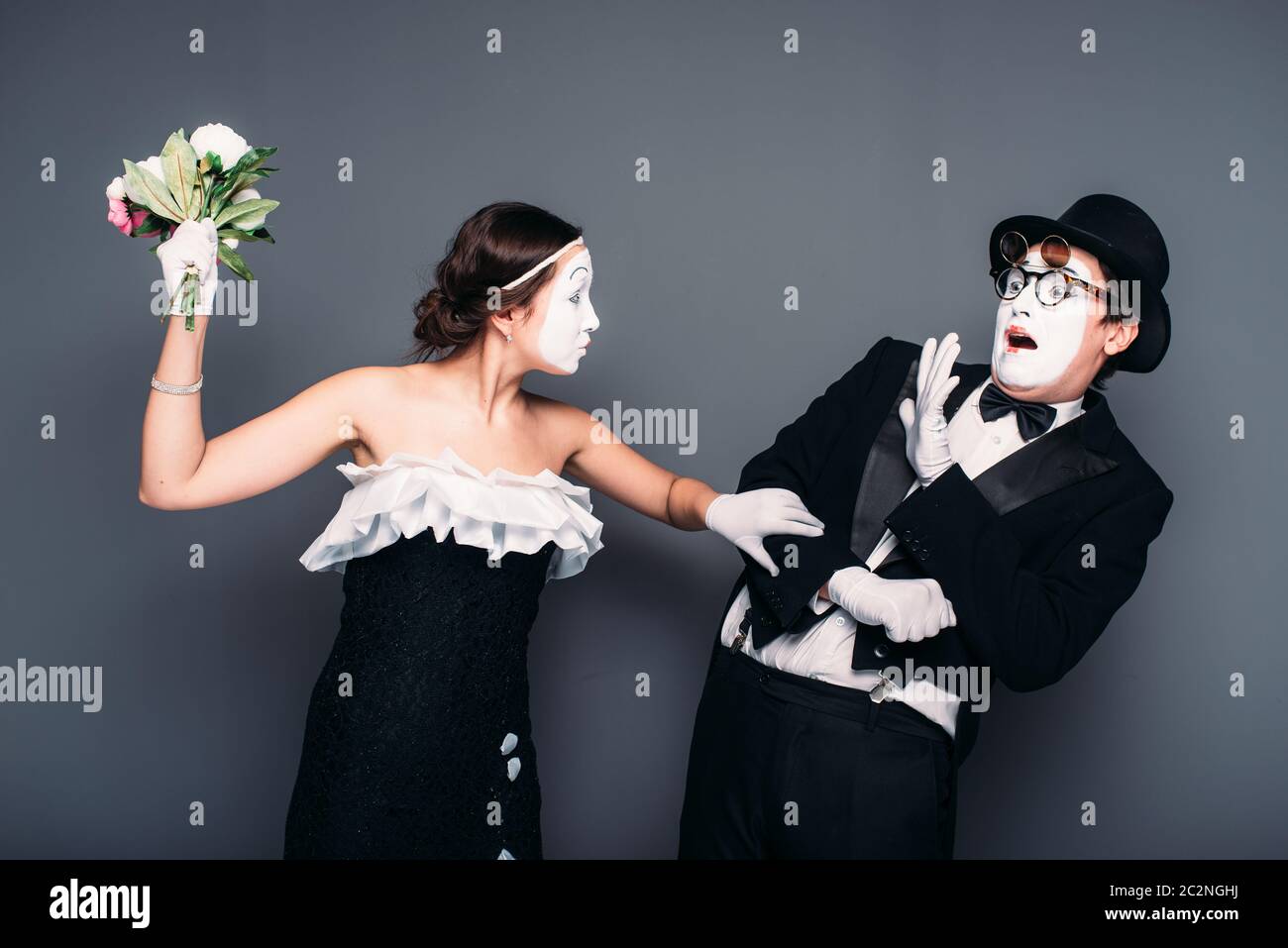 Comedy artists performing with flower bouquet. Mime theater performers ...