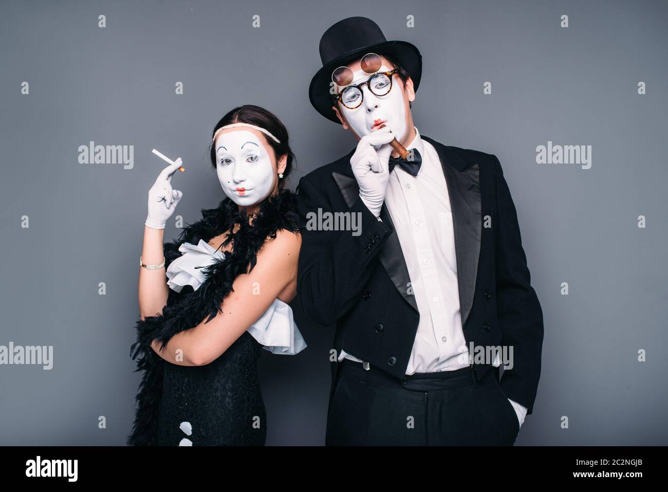 Pantomime actors posing with cigar and cigarette. Comedy artist and ...