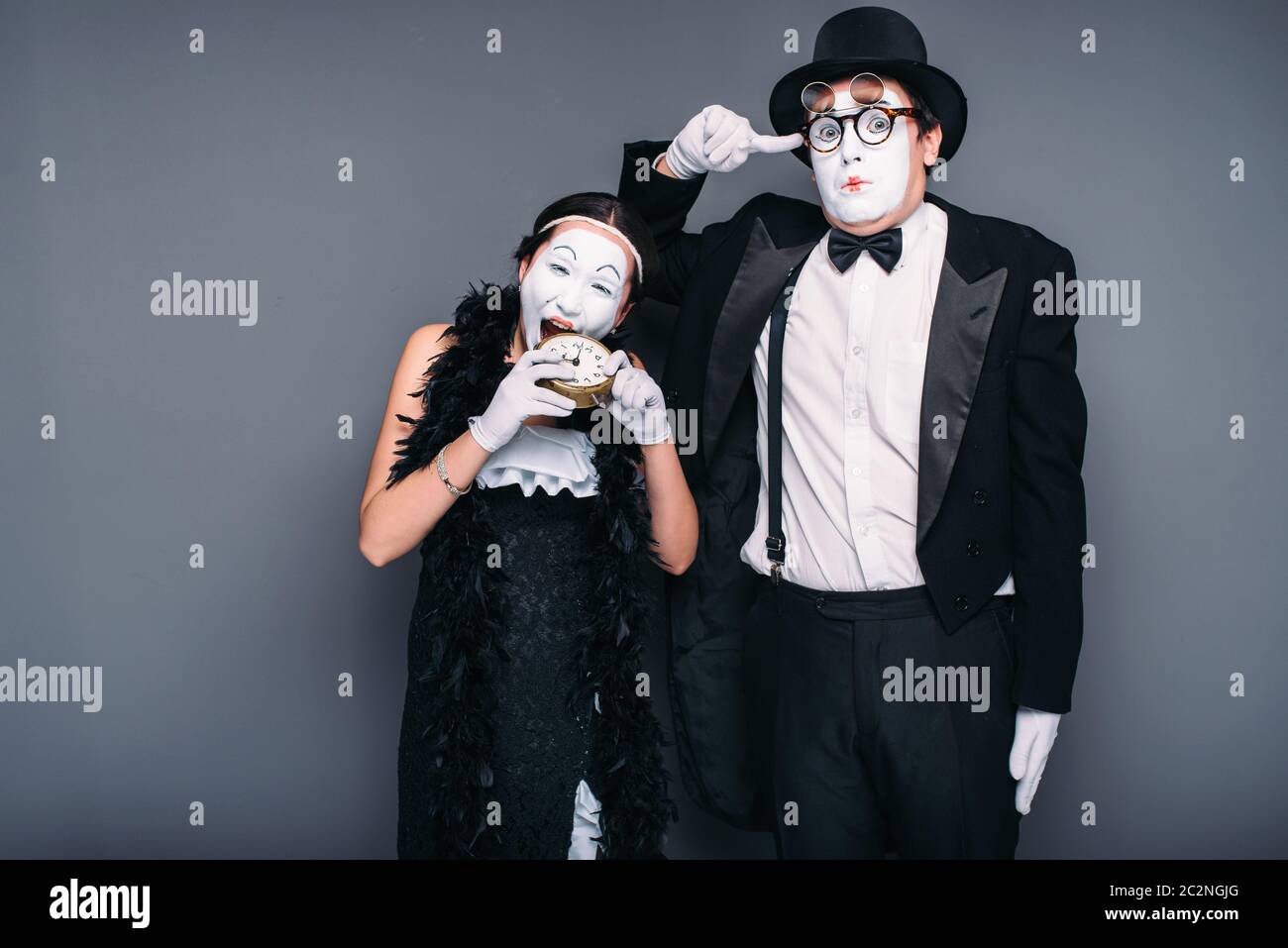 Mime actors performing, actress nibble alarm clock. Pantomime theater ...