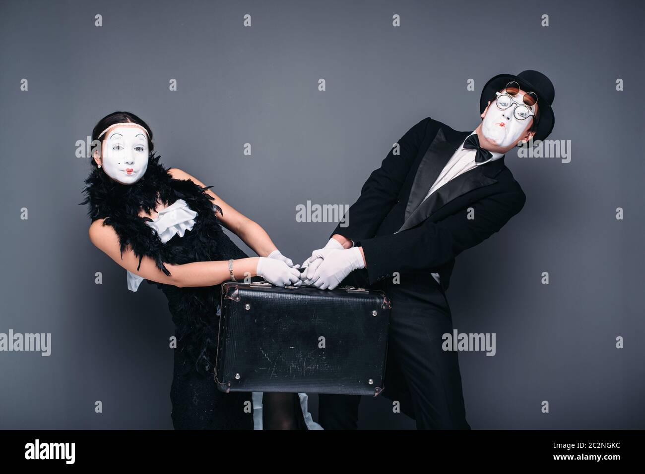 Mime actor and actress performing with suitcase. Pantomime theater ...