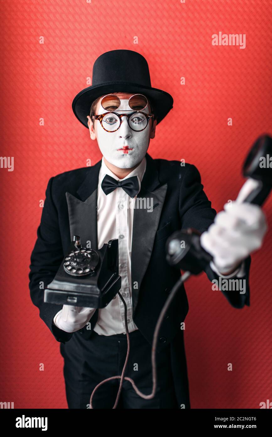 Mime theater actor performing with old telephone. Comedy pantomime ...
