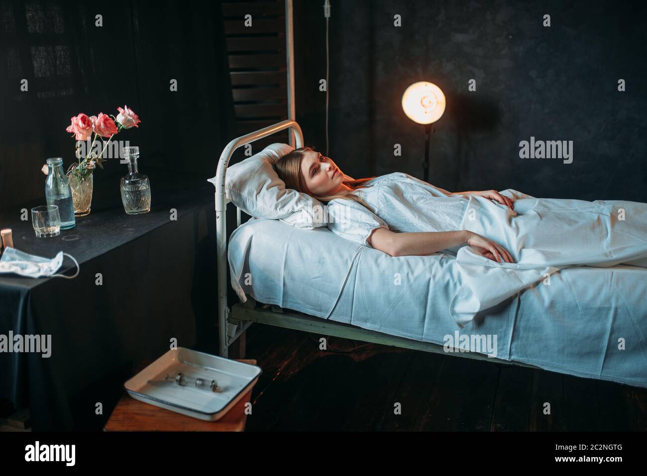 Young ill woman lying in hospital bed. Sick female patient in clinic ...