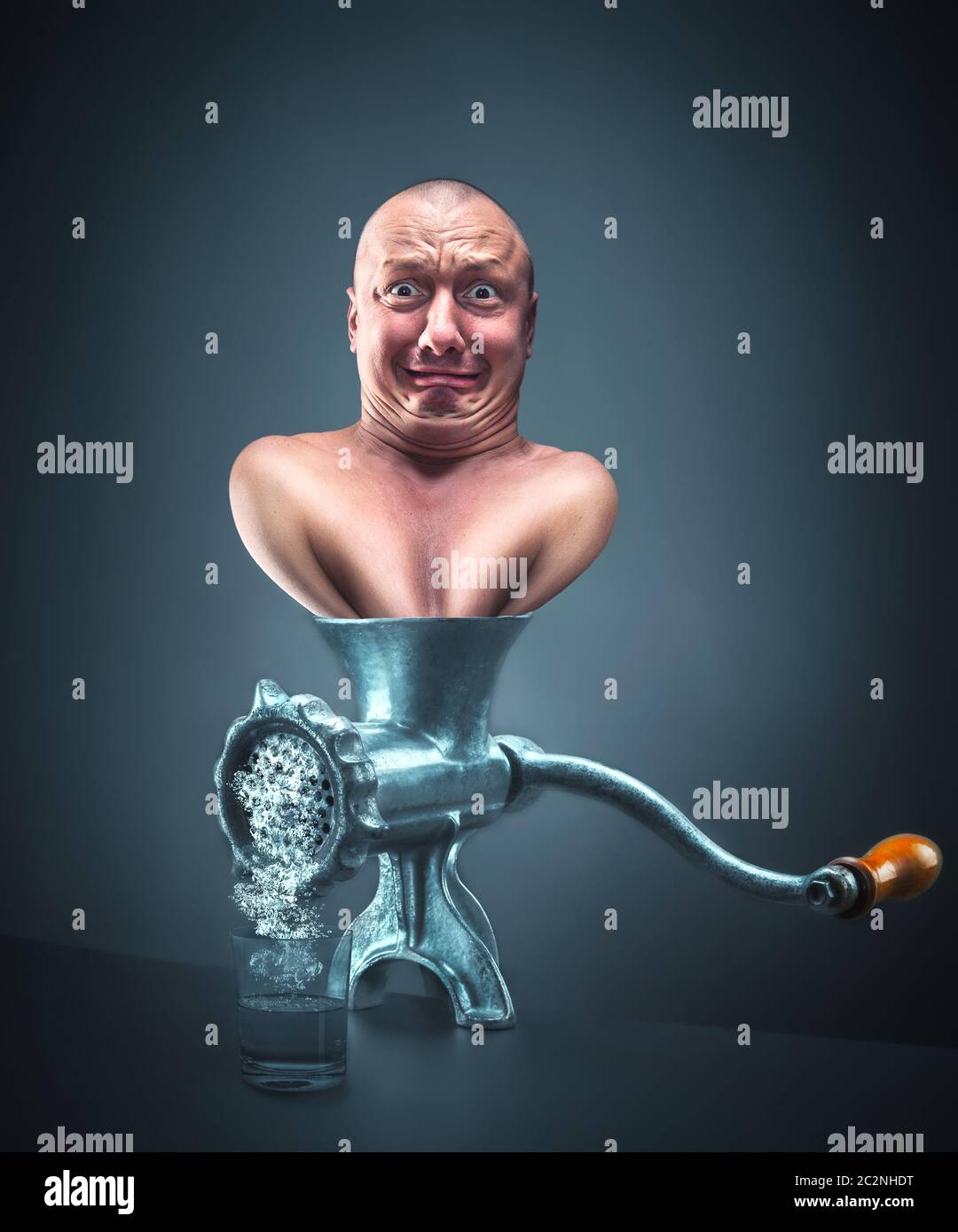 Retro mincing machine with scared man inside Stock Photo - Alamy
