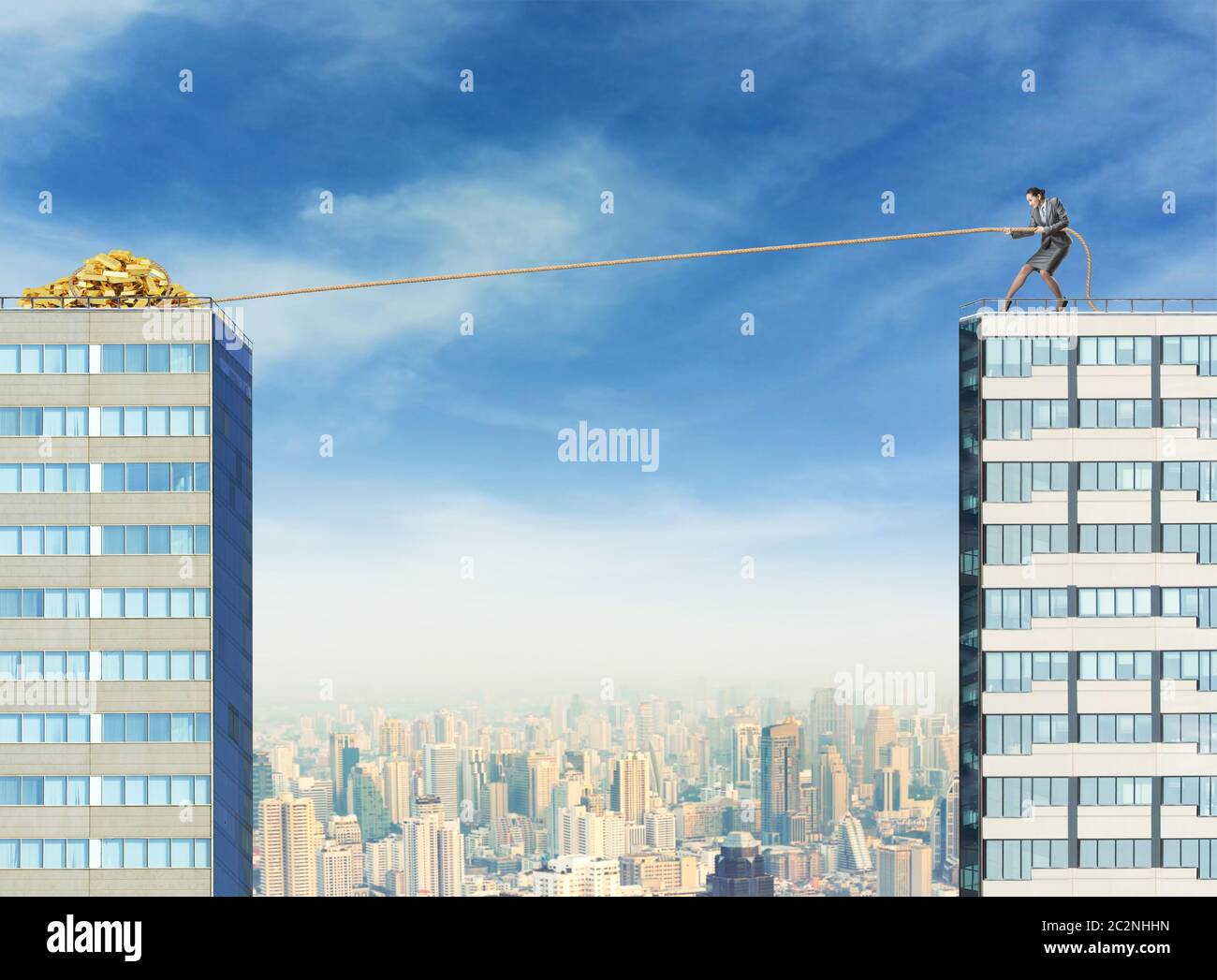 Businesswoman pulls heap of gold bars with the rope from the top of the ...