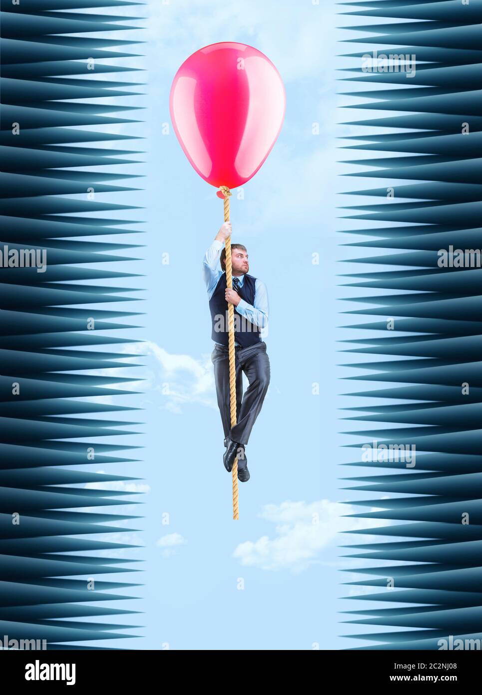 Businessman hanging on the rope with a big ballon in a thorny tunnel ...