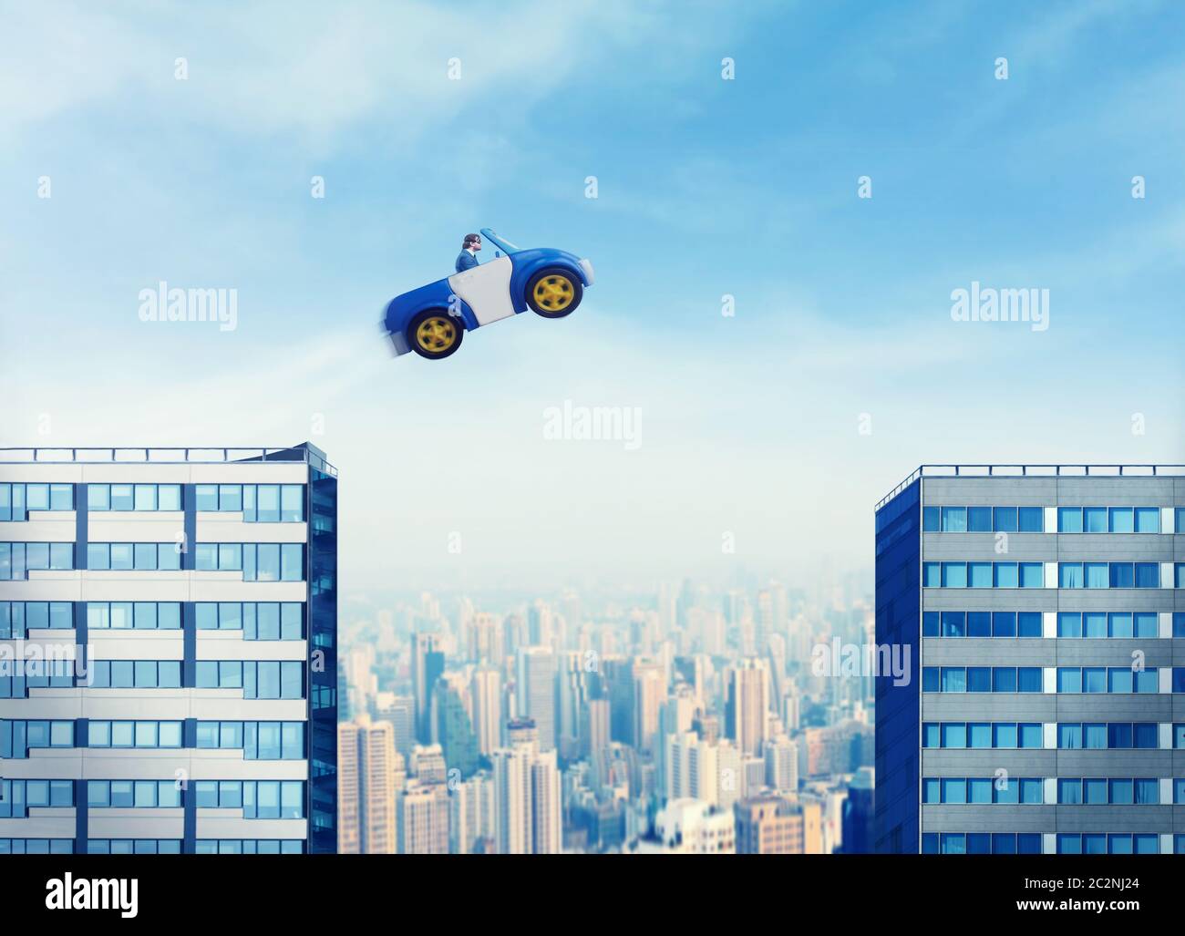 Businessman driving car jumping between two high buildings Stock Photo ...