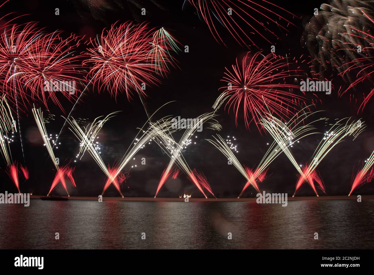 Enjoying a little party with red fireworks in the night Stock Photo - Alamy