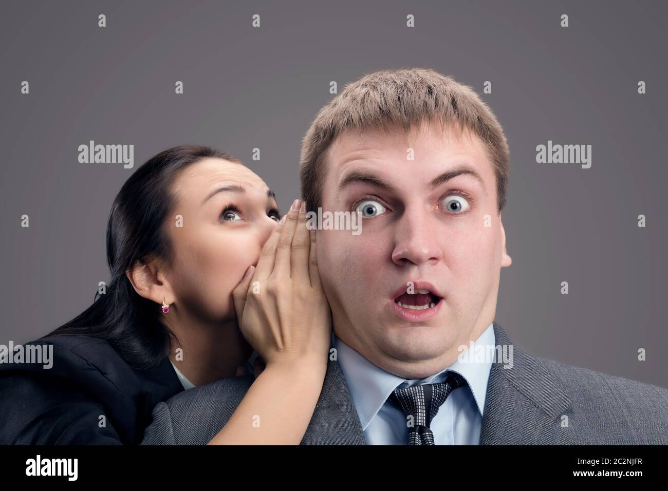 Young man whispers in ear hi-res stock photography and images - Alamy
